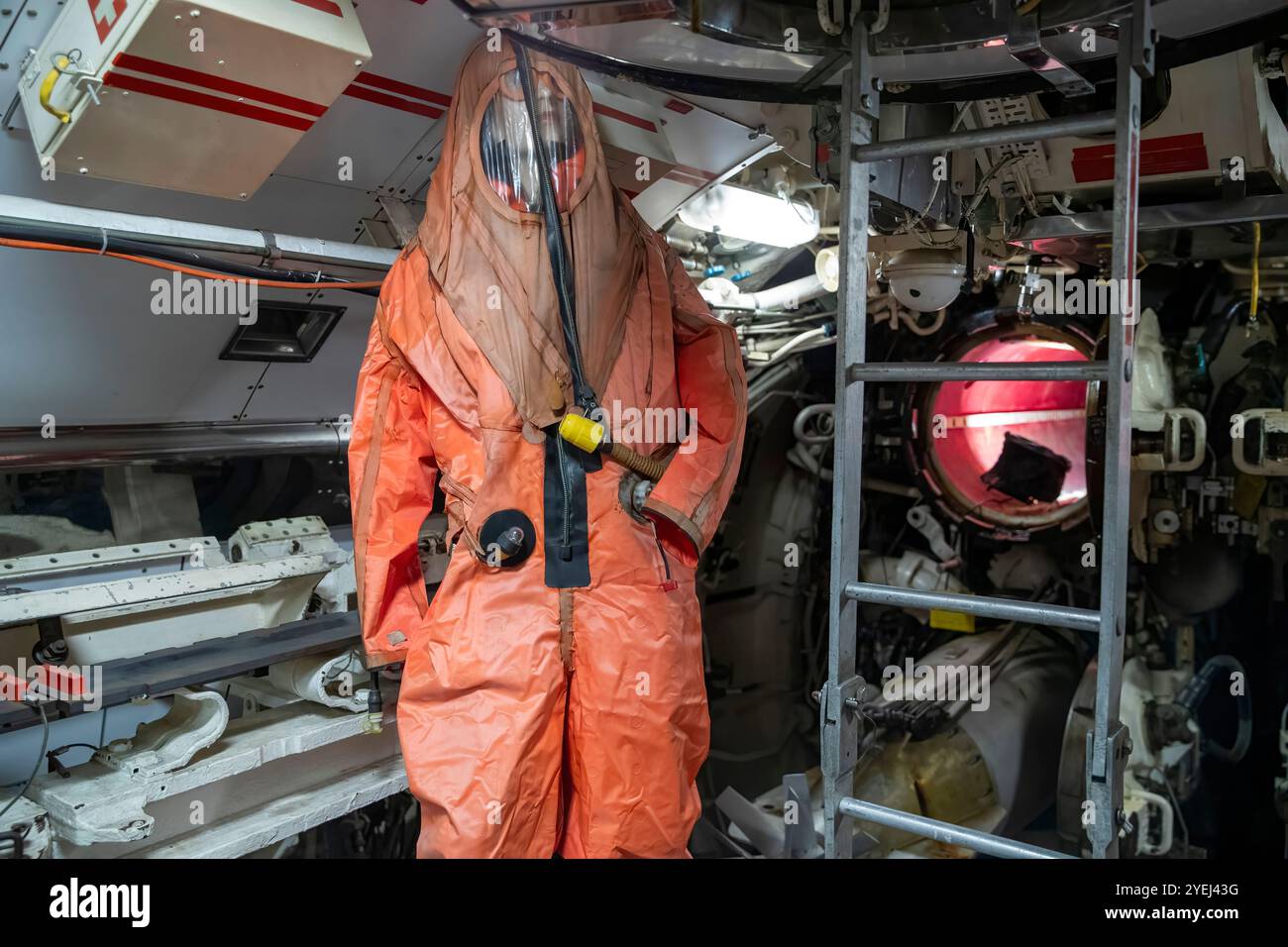 This photograph shows a safety or survival suit displayed inside a ...