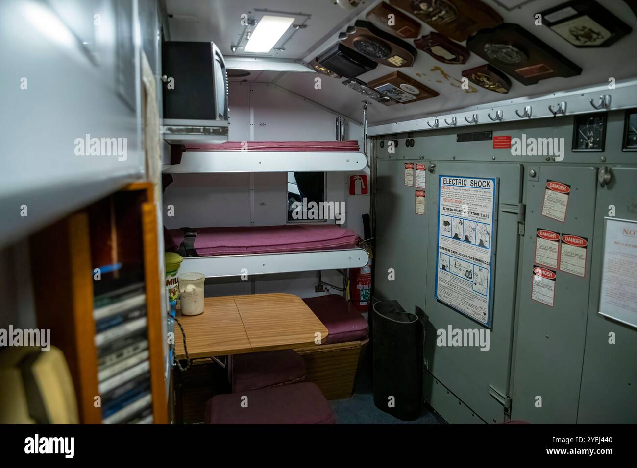 This photograph shows the interior of a submarine cabin, featuring bunk ...