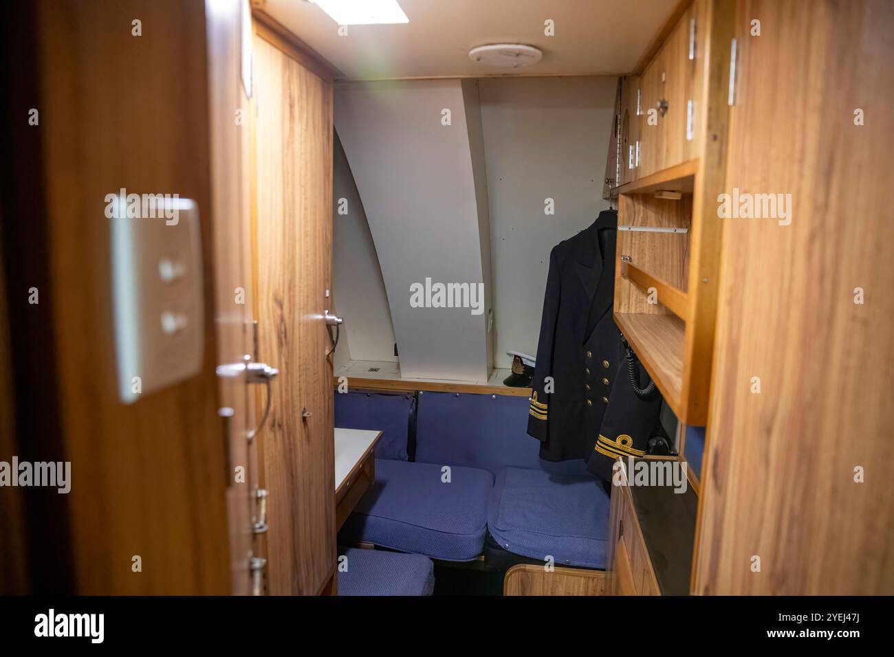 Interior view of a small cabin on a ship or submarine, featuring a ...