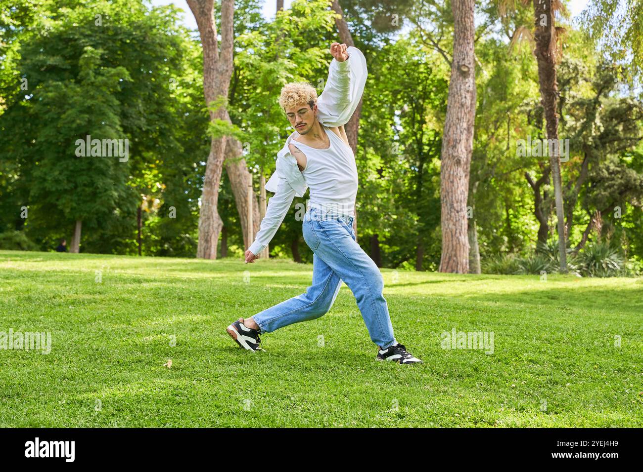 young man in jeans and white shirt dancing contemporary dance in the ...