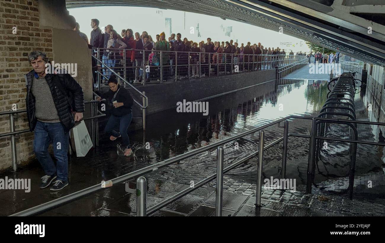 Londoners jumping over large accumulations of water on city pathways ...