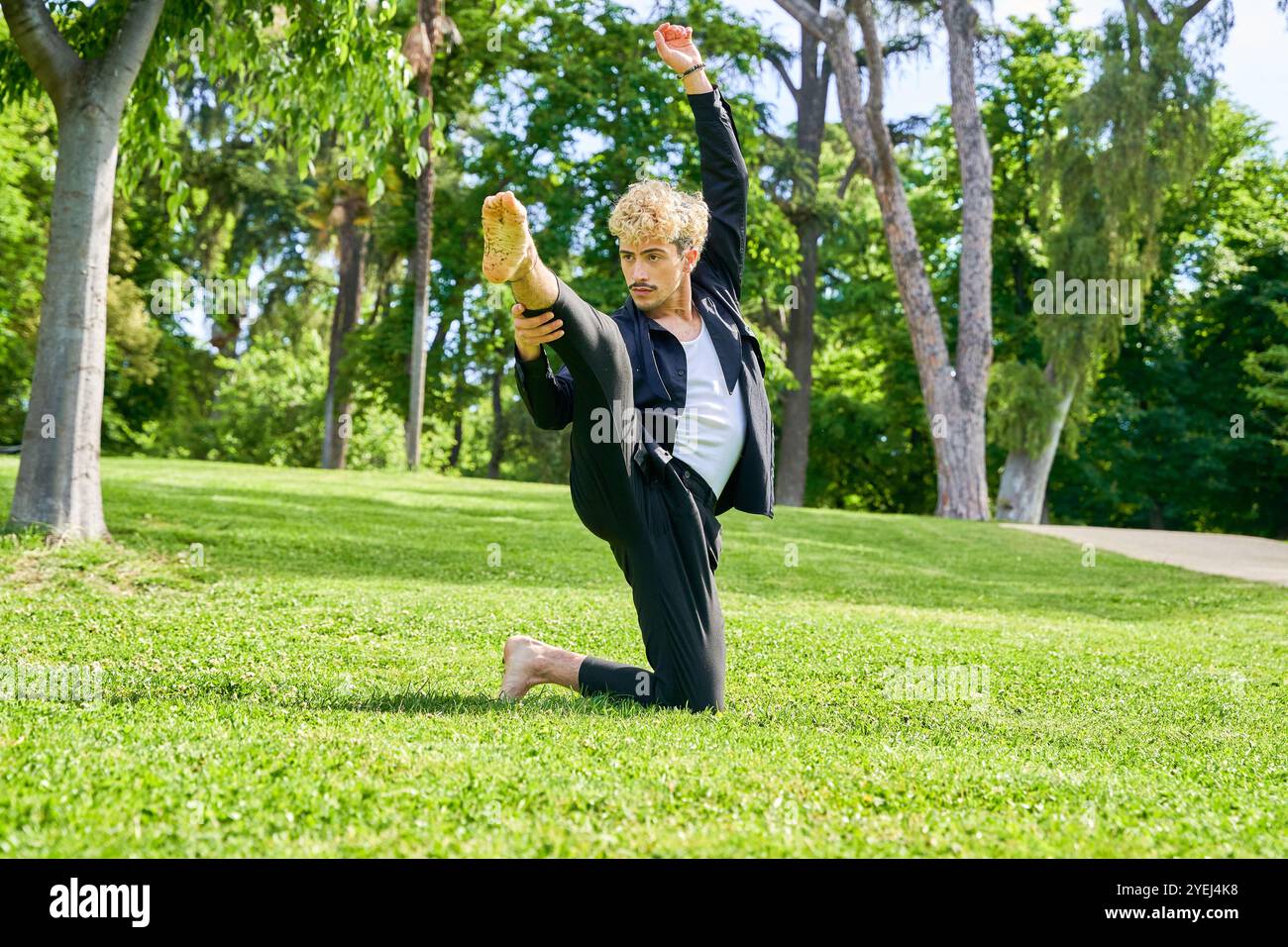 young man jumping and dancing contemporary ballet in the park with ...