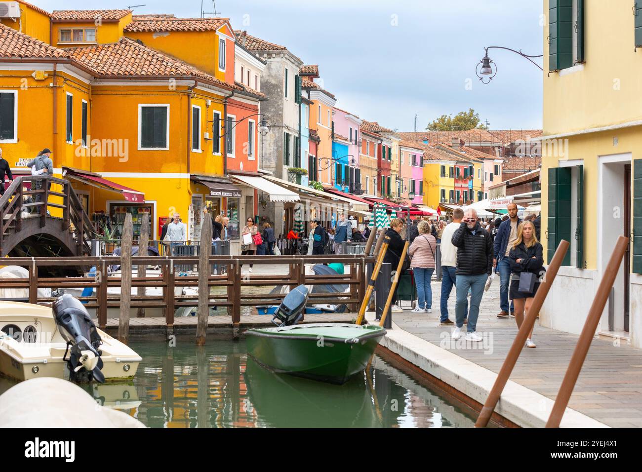 Burano island, Italy - October 1, 2024: Colorful houses architecture, canal and street in famous ...