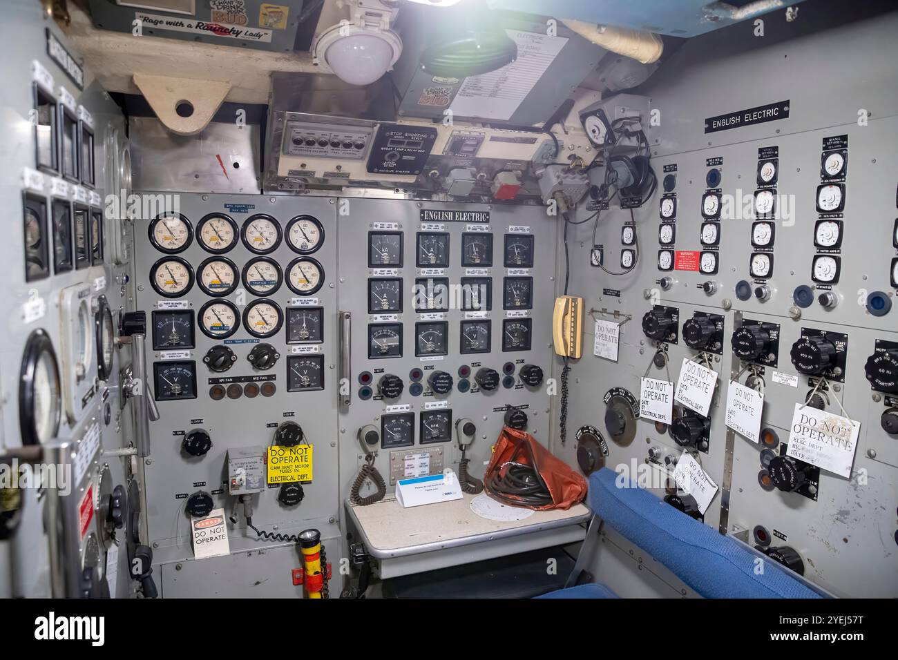This photograph shows a submarine control room filled with numerous ...