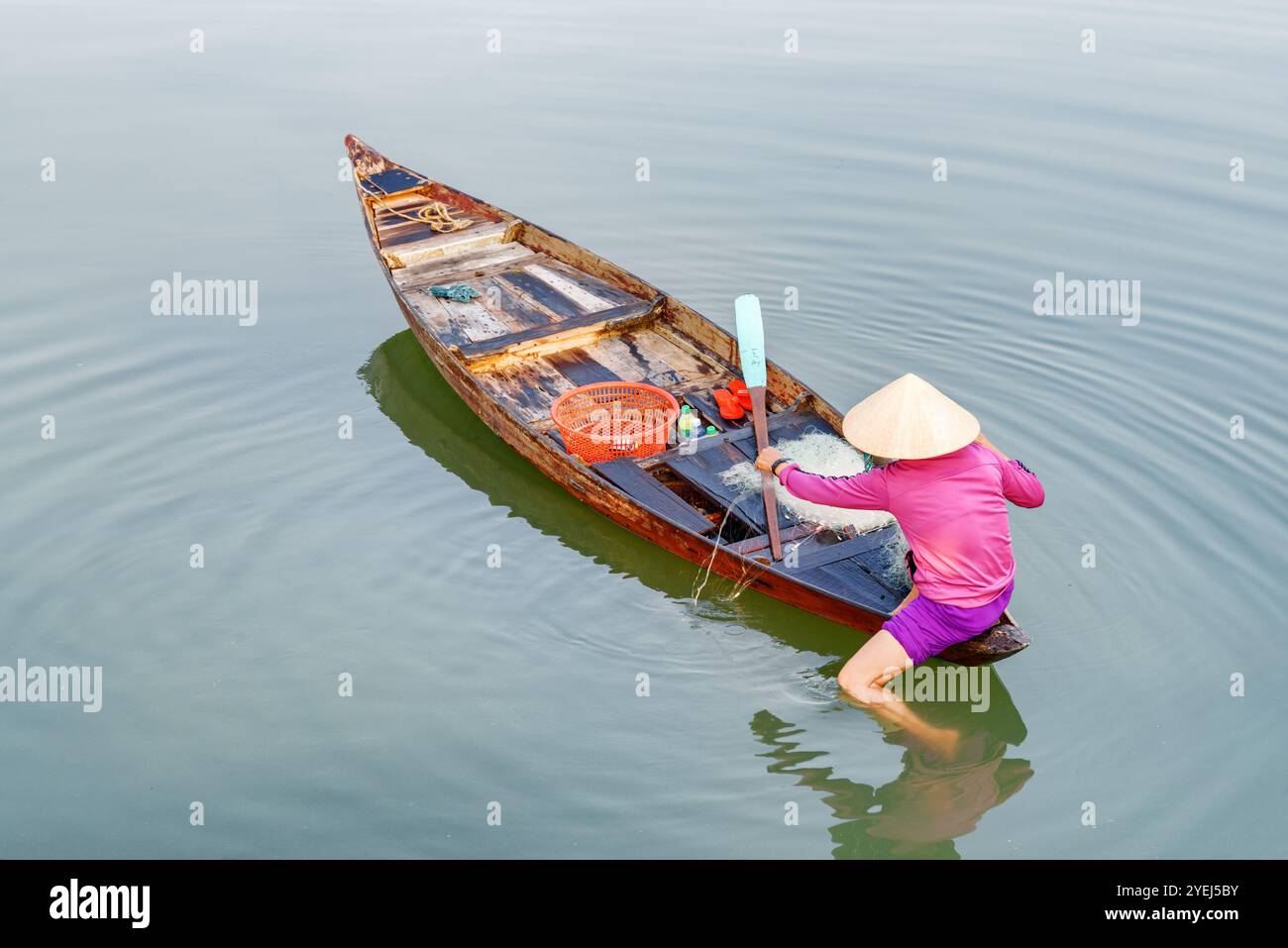 Unusual view of Vietnamese woman checking her fishing net, Hoian Stock ...