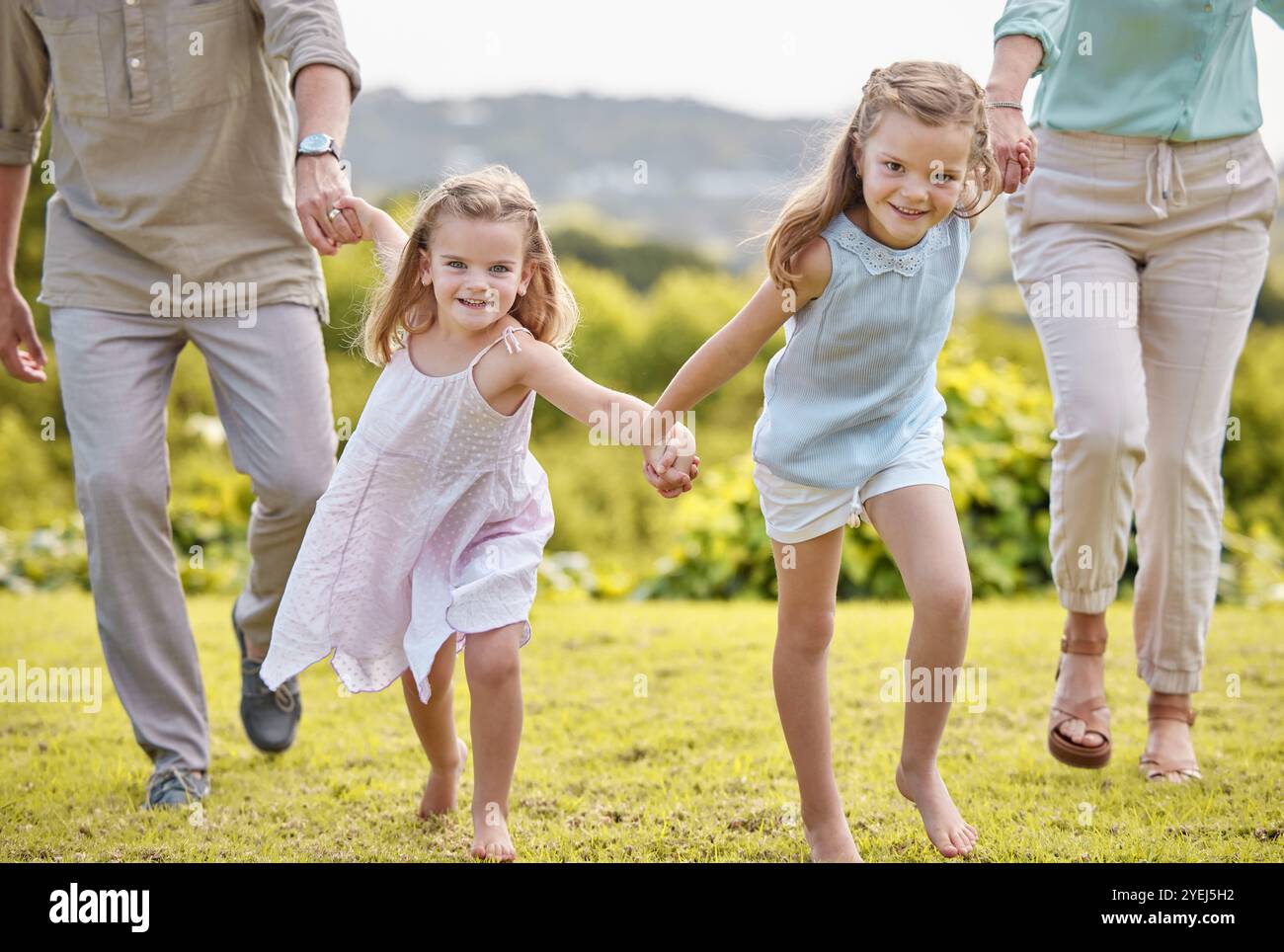 Happy family running holding hands hi-res stock photography and images ...