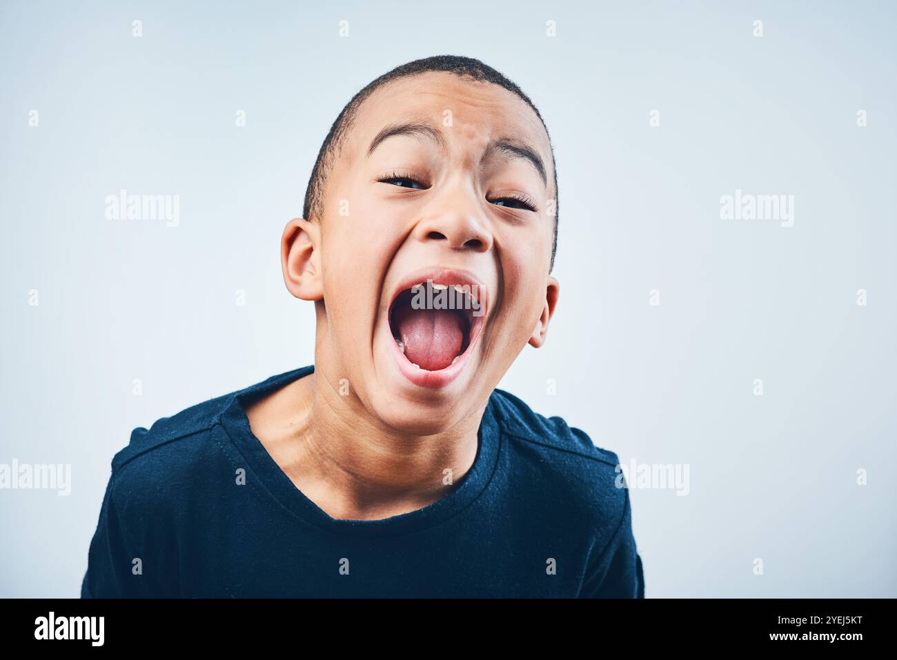 Shout, scream and portrait of kid in studio with anger, upset and mad ...