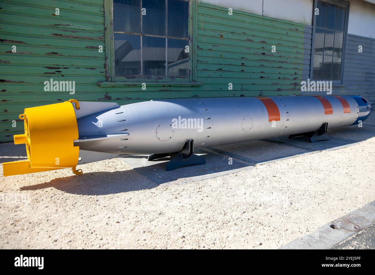 The torpedo, painted primarily in grey with yellow and orange accents ...