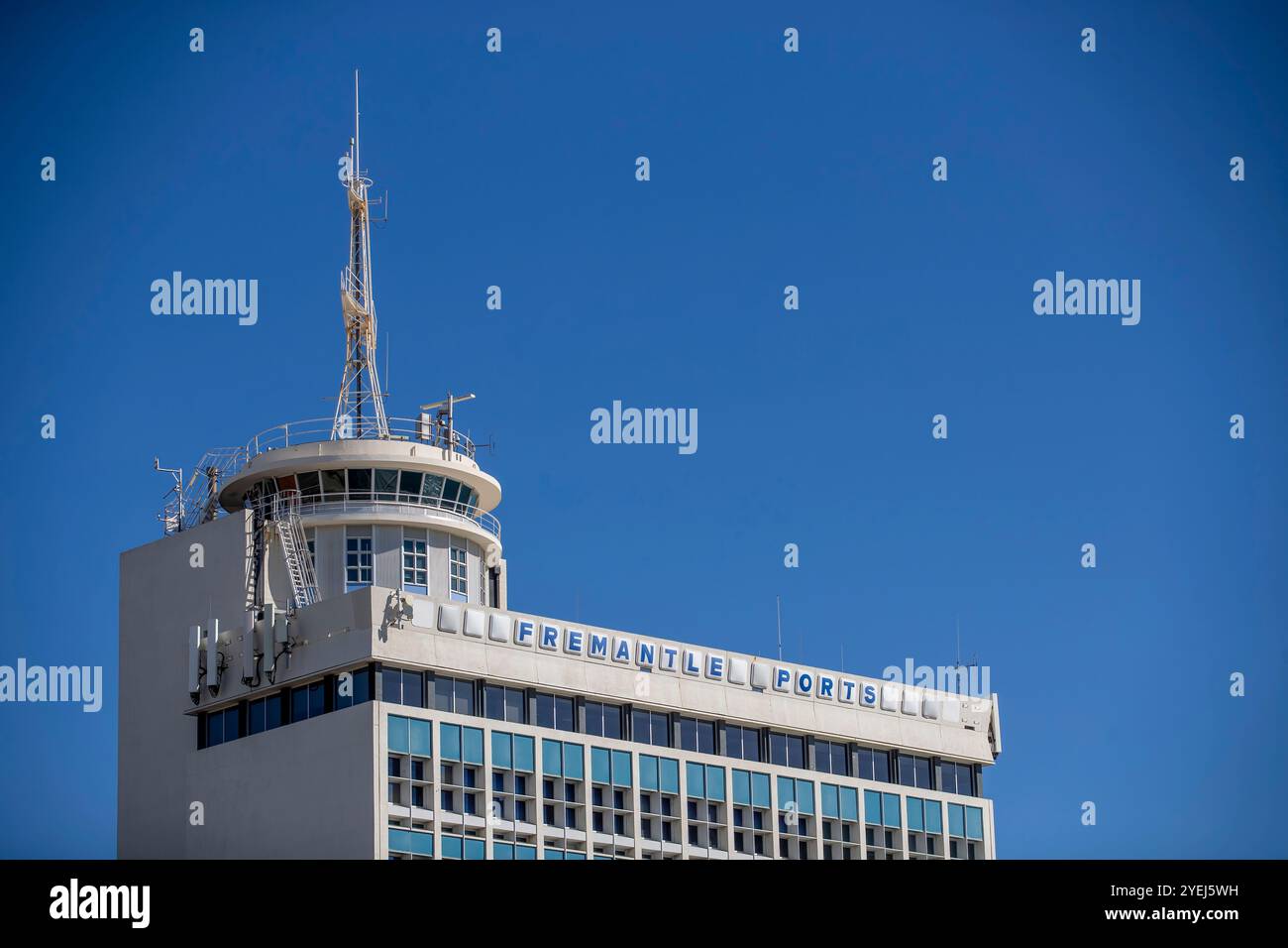 The Fremantle Ports building under a bright blue sky. The building is a ...