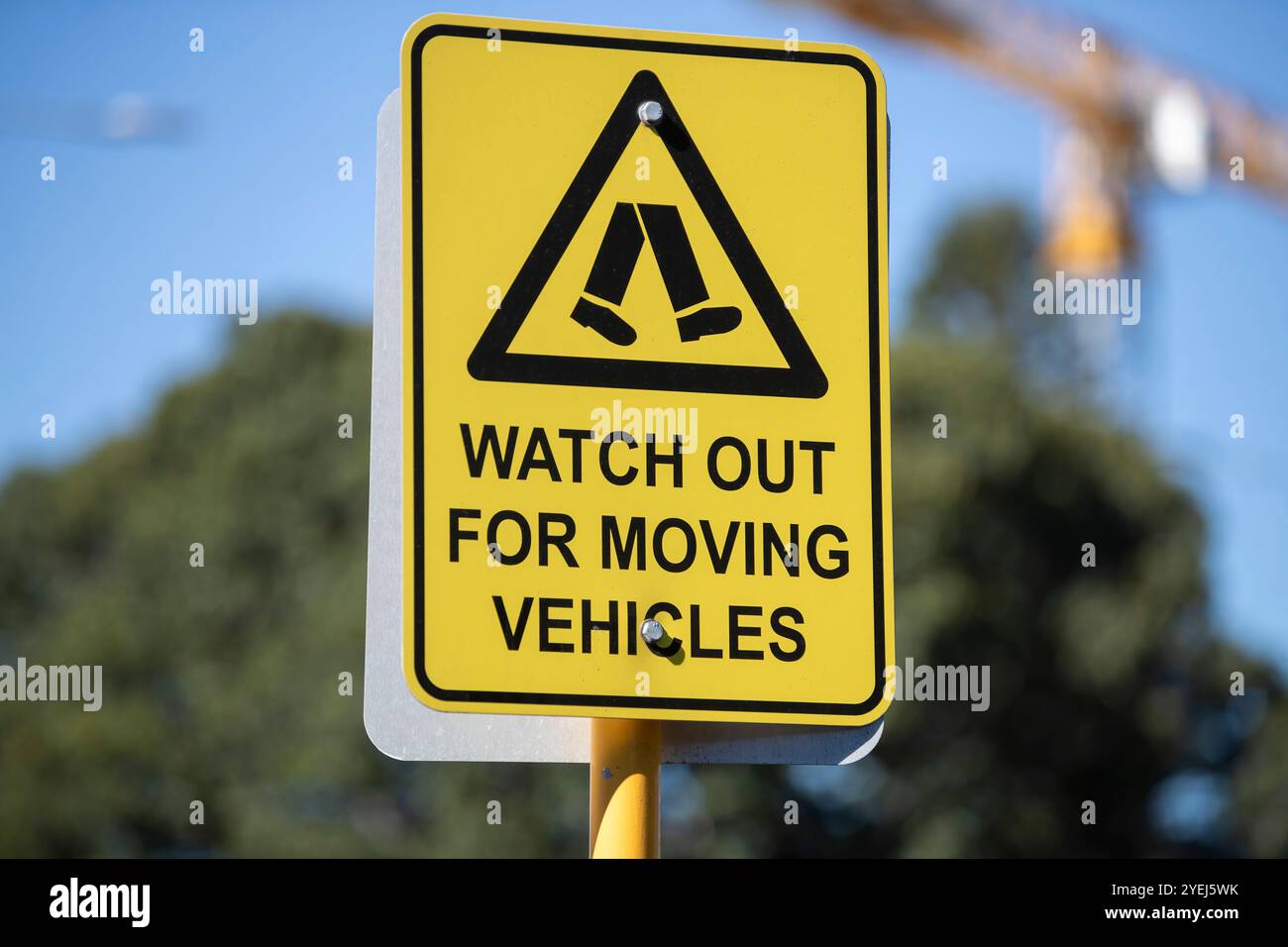 A bright yellow warning sign with a triangular caution symbol ...