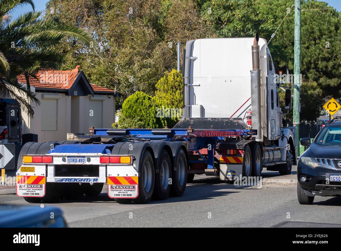 A rear view of a Freightliner coronado semi-truck with an empty trailer ...