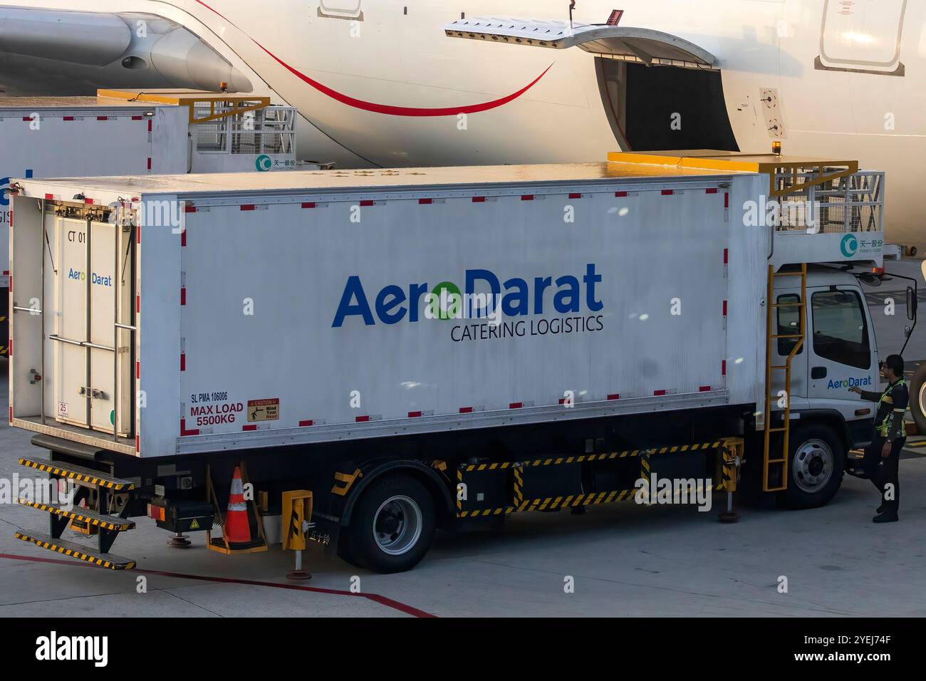A white catering truck labeled "AeroDarat Catering Logistics" parked ...