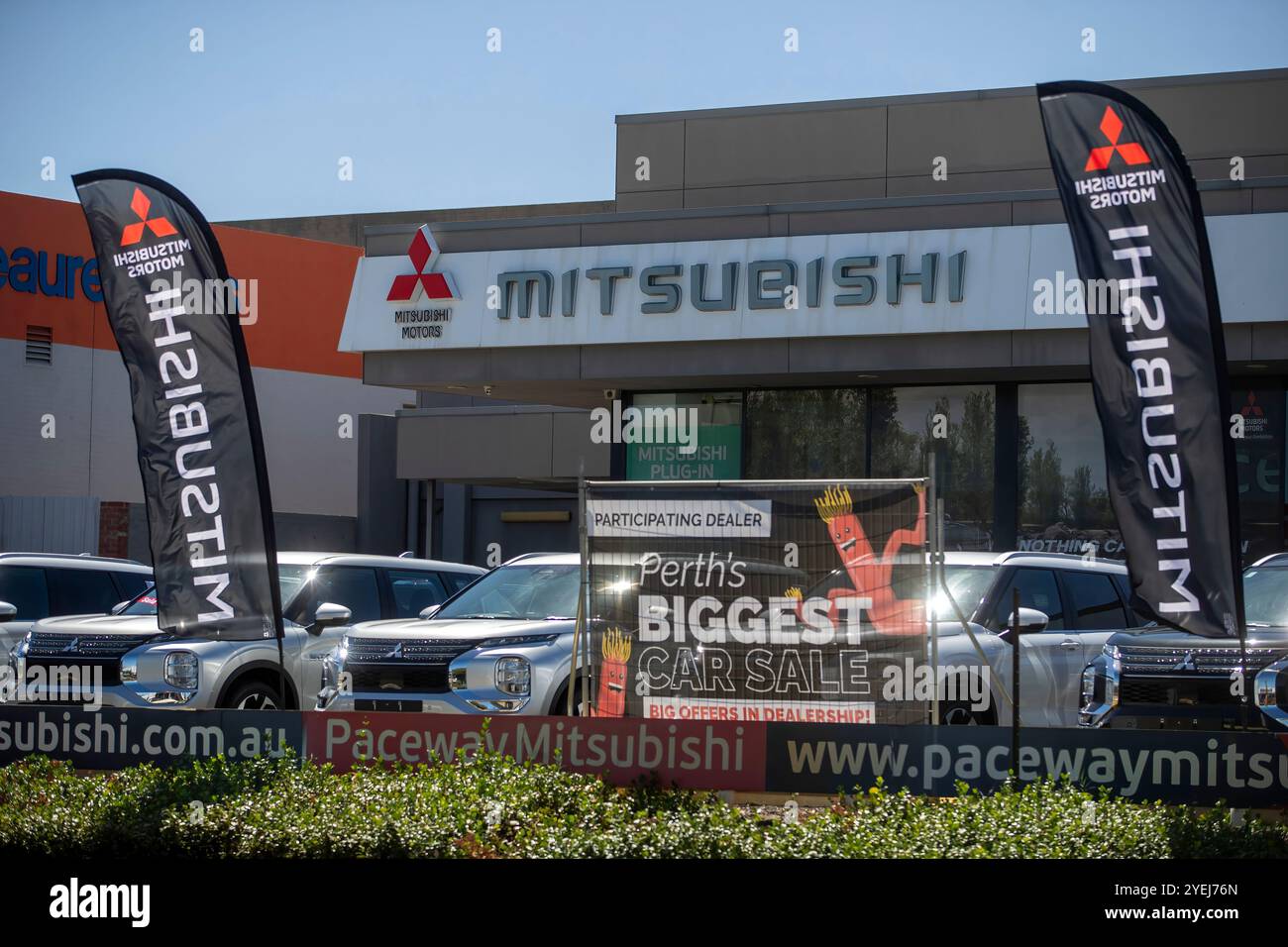 Mitsubishi Motors dealership exterior featuring promotional banners ...