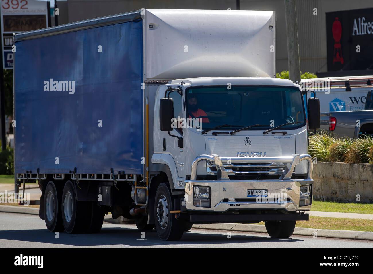 Isuzu F Series FVL240-300 Freightpack driving down a suburban road ...