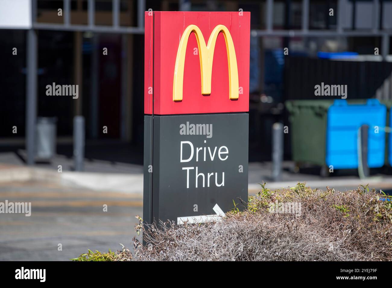 A McDonald's drive-thru sign with the iconic golden arches and a ...