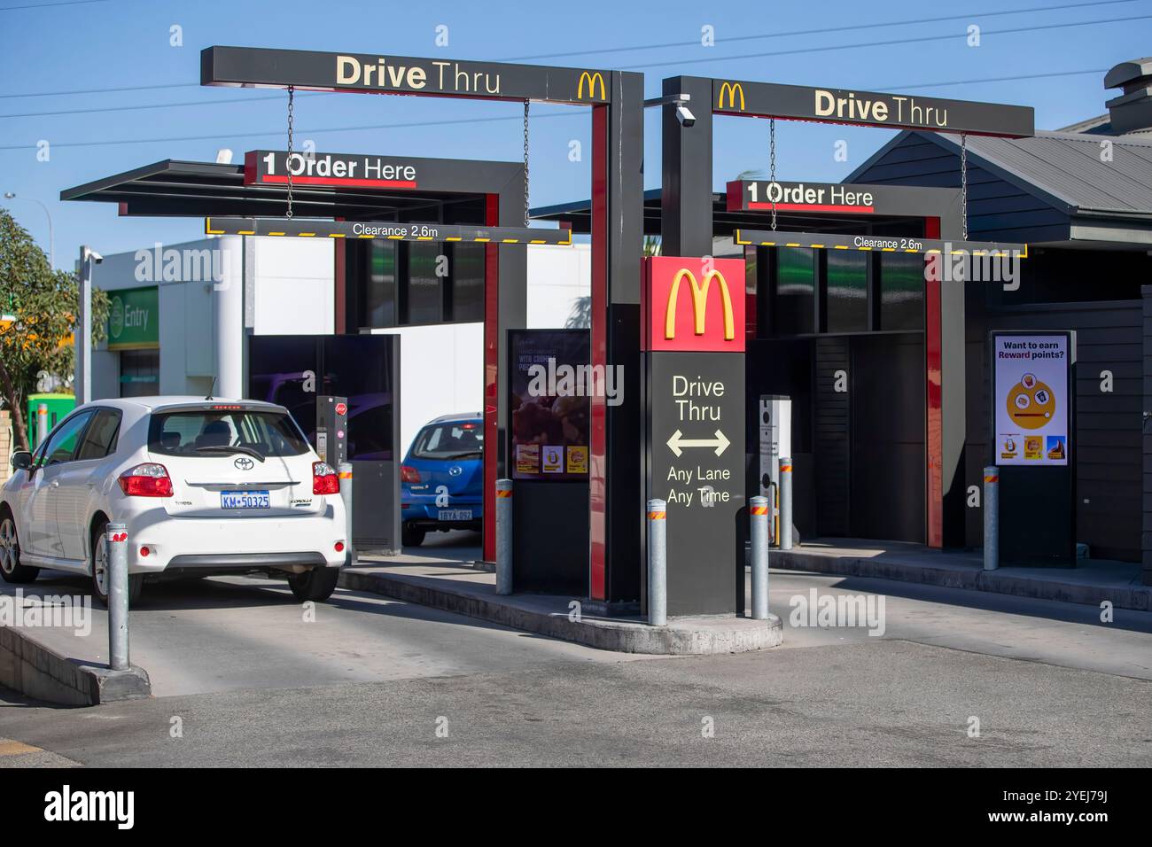 A McDonald's drive-thru with two ordering lanes, featuring cars waiting ...