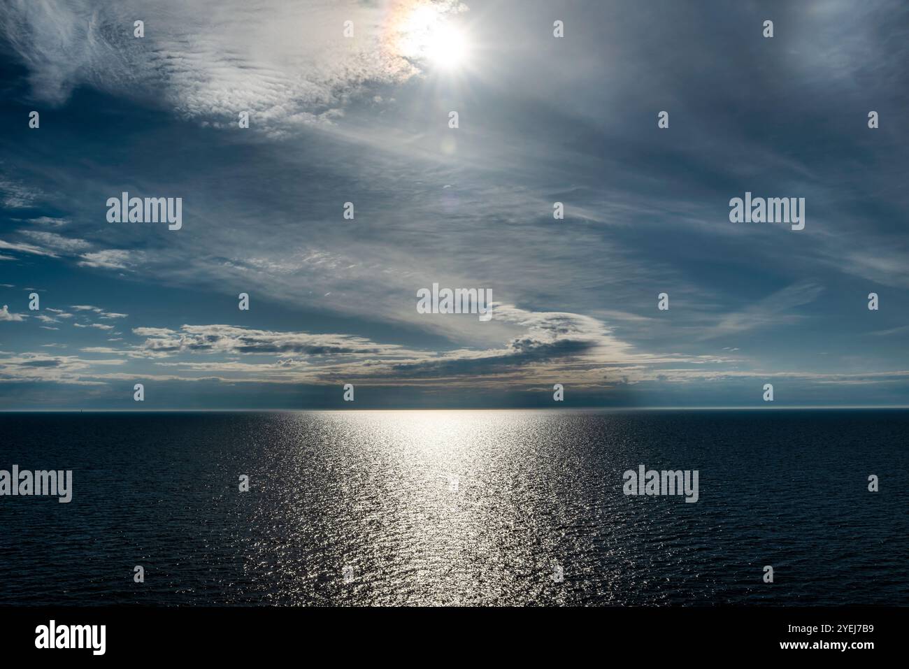 Baltic sea at sunrise. Beautiful sky with white clouds hiding the sun ...