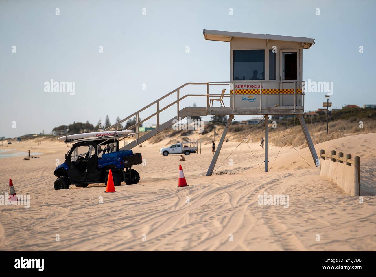 The photo shows a lifeguard tower elevated on metal legs with a ...