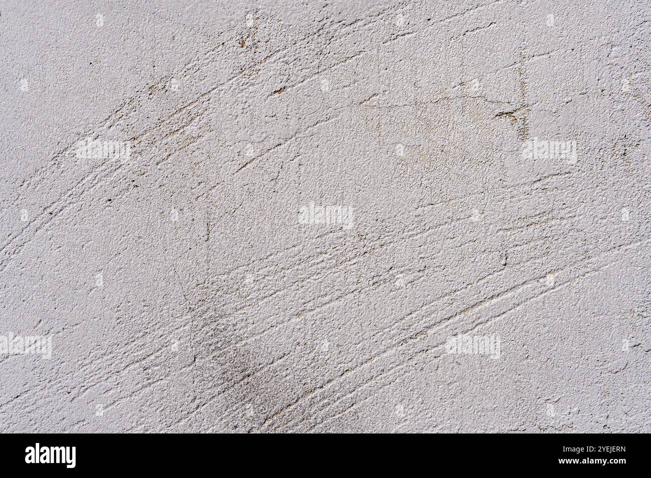 Rough concrete surface in light gray with visible diagonal scratches ...