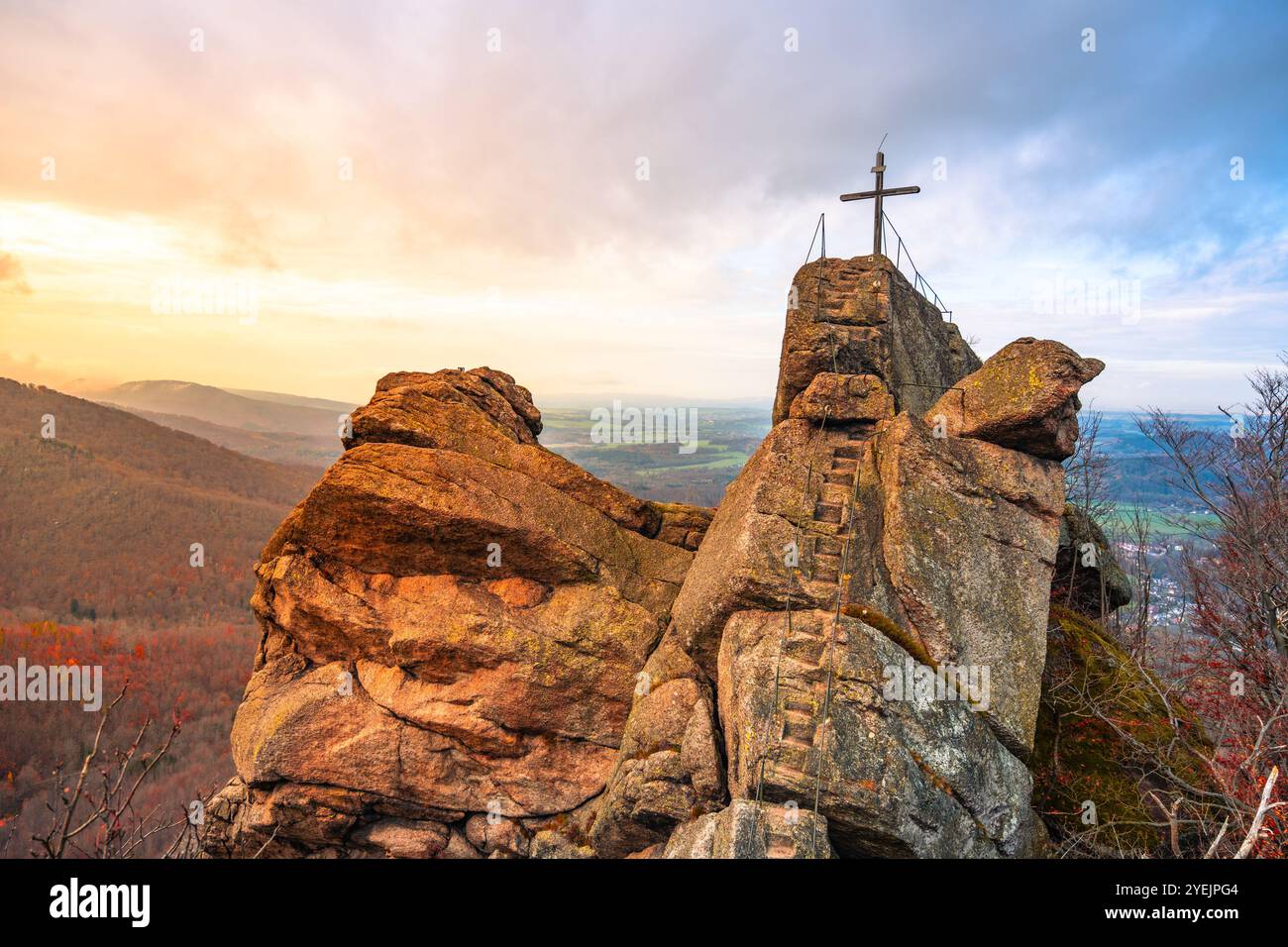 The sun sets behind the Oresnik granite rock formation, illuminating a ...