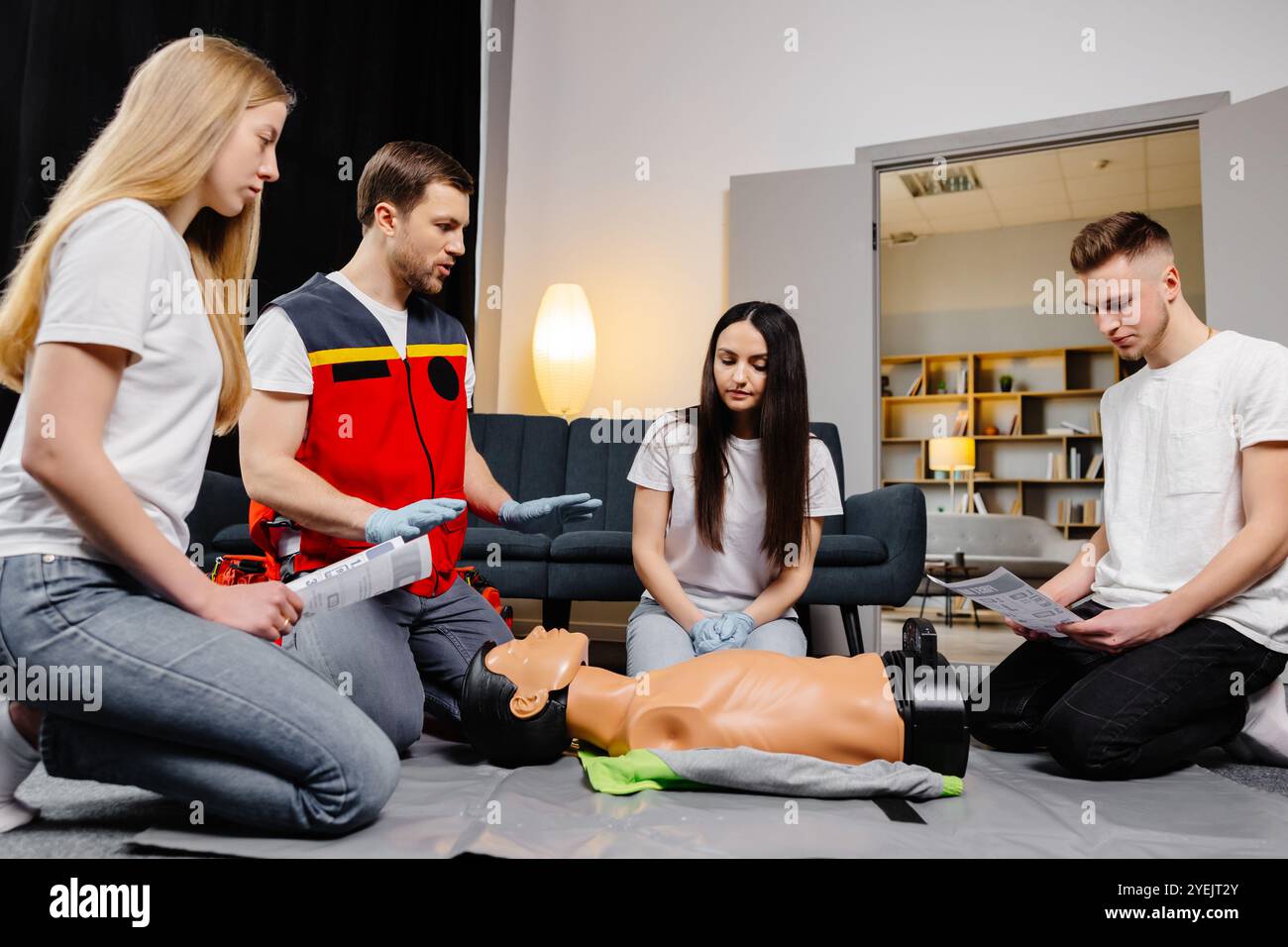 Group of people learning how to make first aid heart compressions with ...