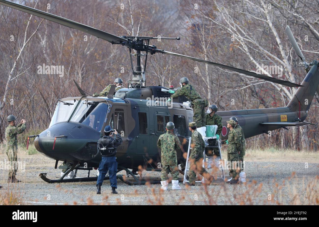 Japan Self-Defence Forces members decontaminate their helicopter in an ...