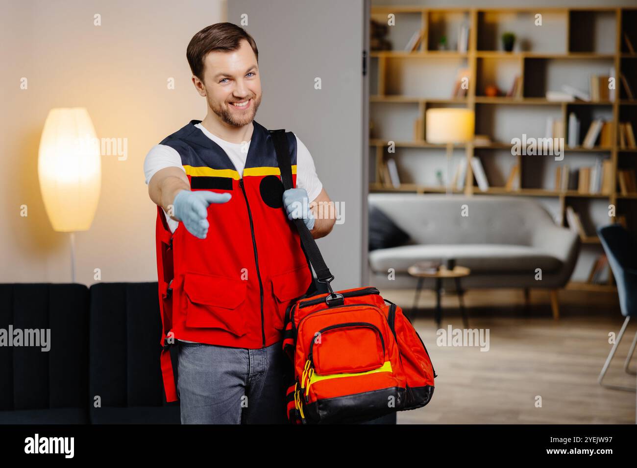 First aid course. A young male paramedic with a bag on his shoulders is ...