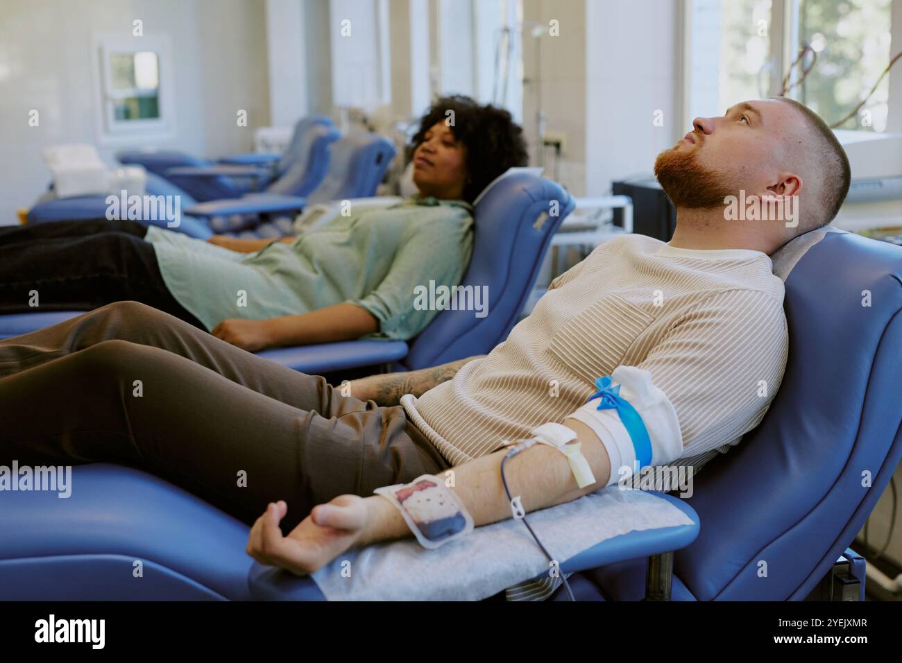 After settling into reclining chairs, patients are undergoing blood ...