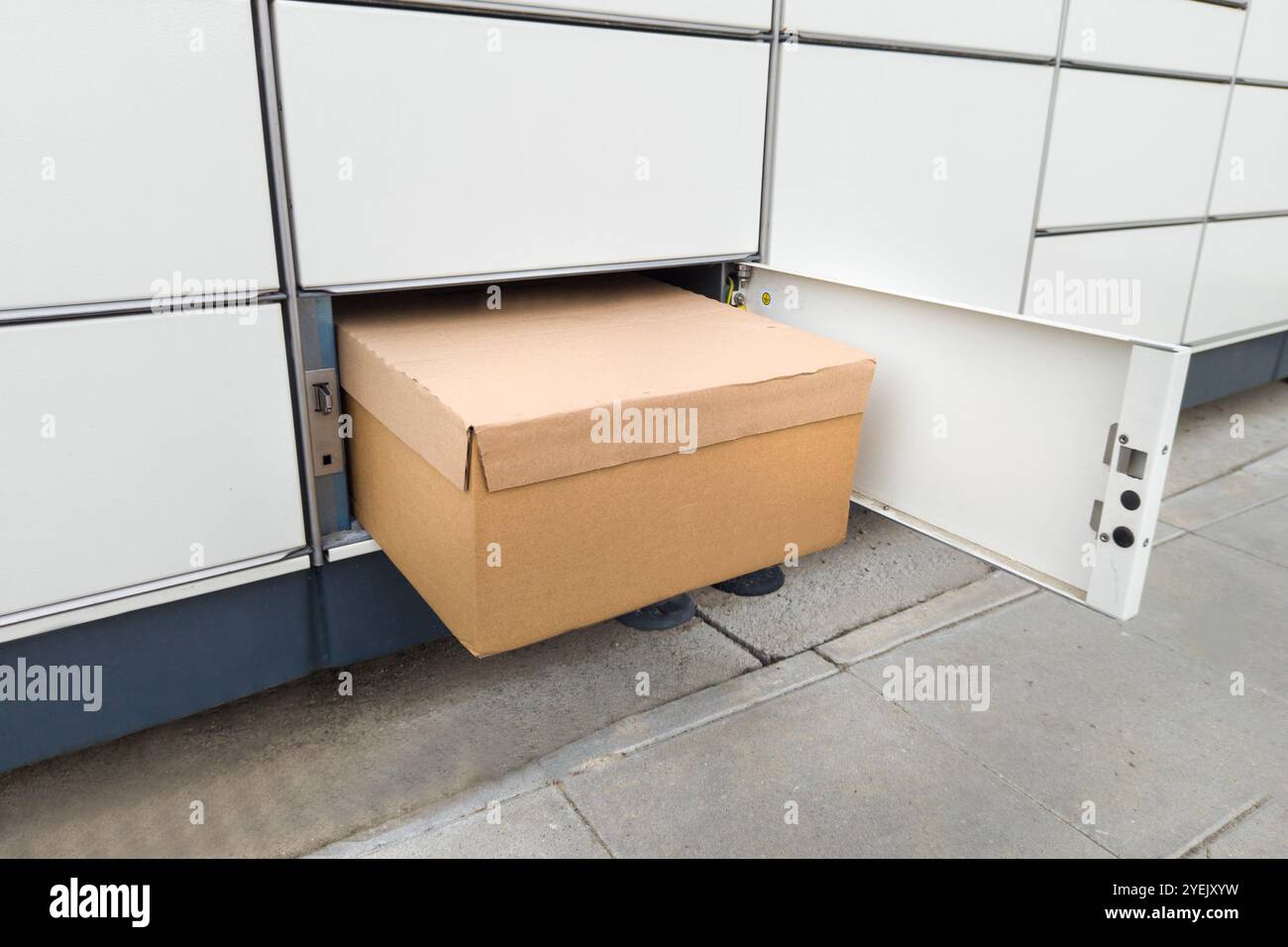 Cardboard Parcel in Open Locker for Pickup Stock Photo - Alamy