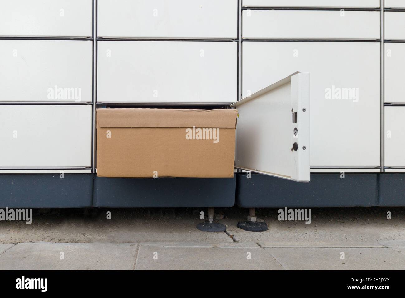 Cardboard Package in Open Parcel Locker Compartment Stock Photo - Alamy