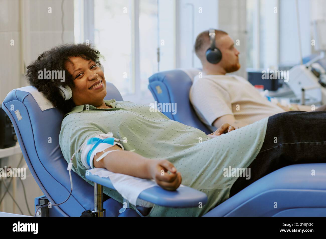 African American woman and Caucasian man donating blood while relaxing ...