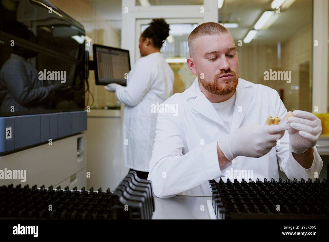 Young Caucasian male scientist examining sample while wearing ...