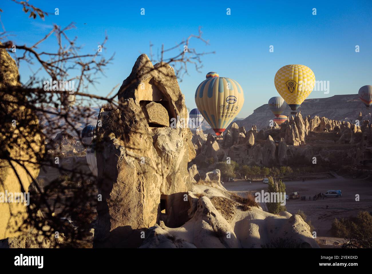 Colorful hot air balloons ascend gracefully above Cappadocia's unique ...