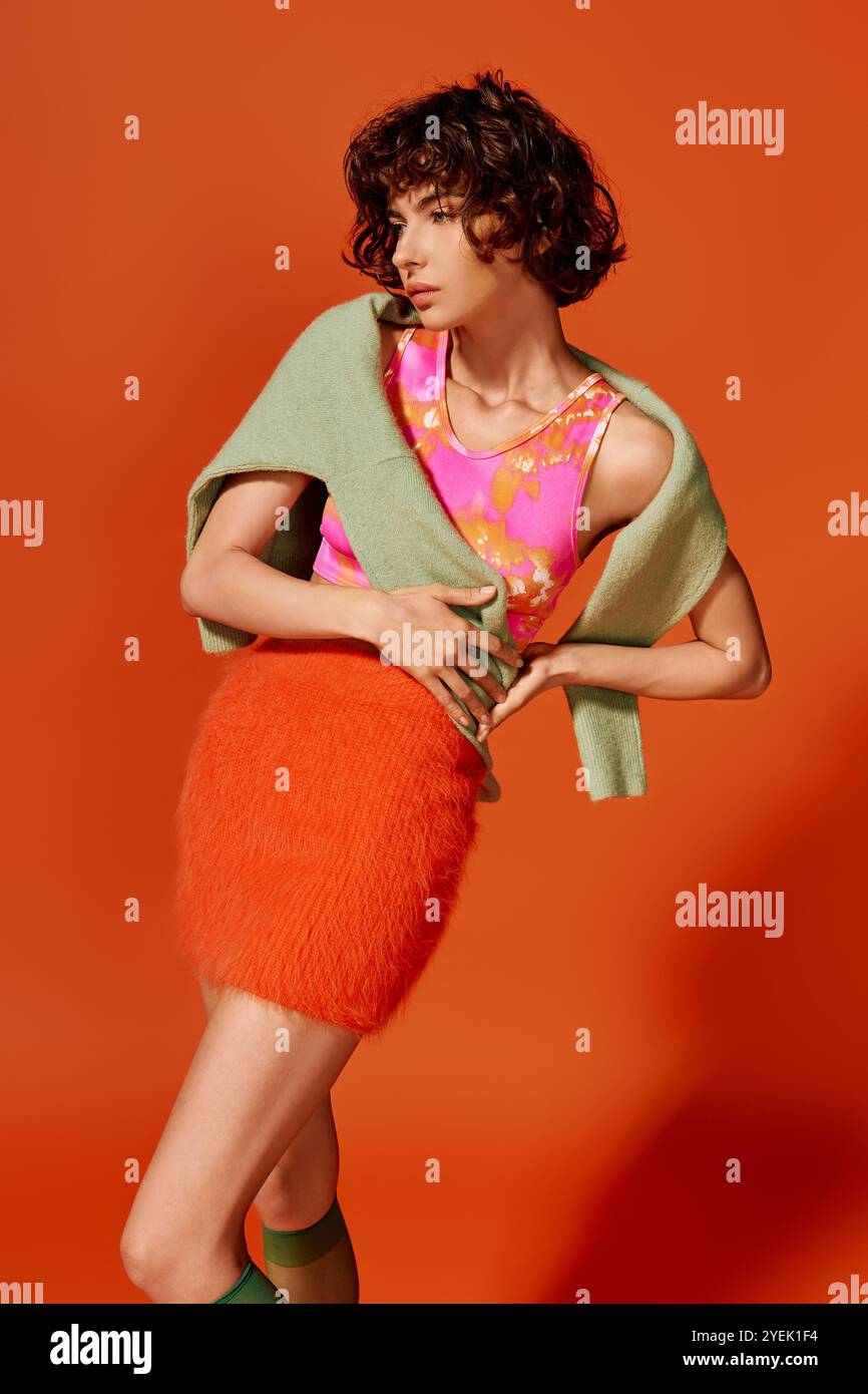 A young woman expresses emotion while showcasing a colorful outfit in a ...