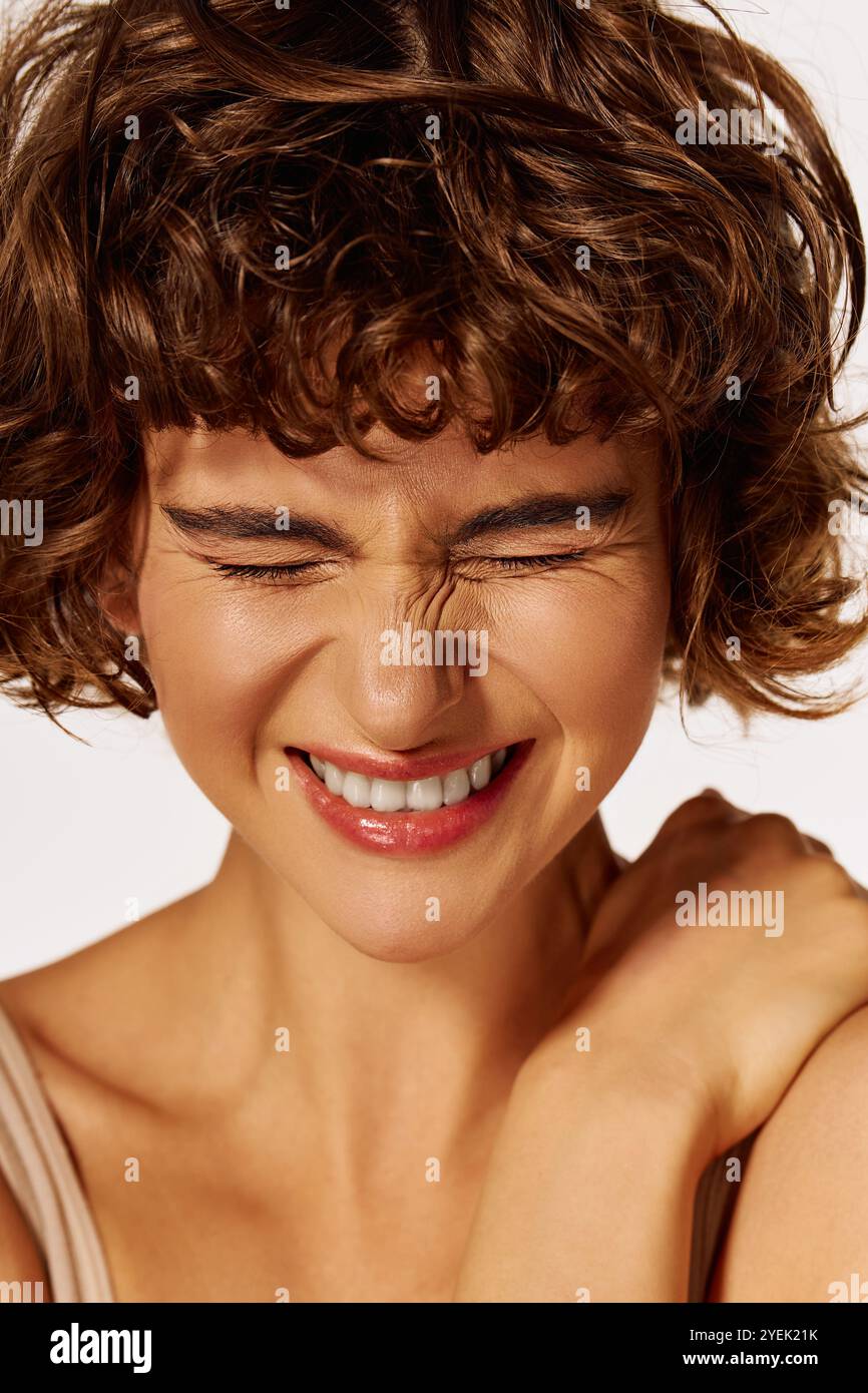 A young woman with short curls captures a heartfelt moment of joy ...