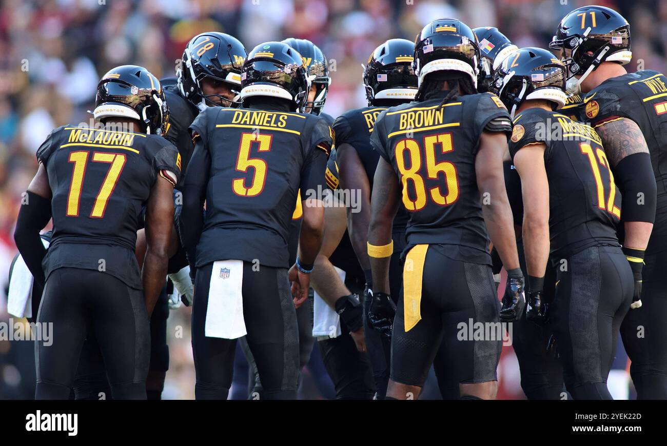 Washington Commanders players huddle up during an NFL football game ...
