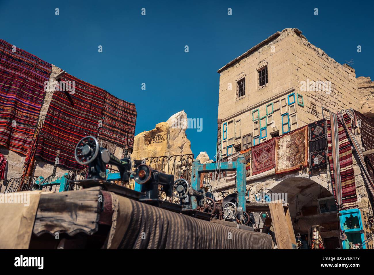 Vibrant textiles hang from rustic buildings as artisans display their ...