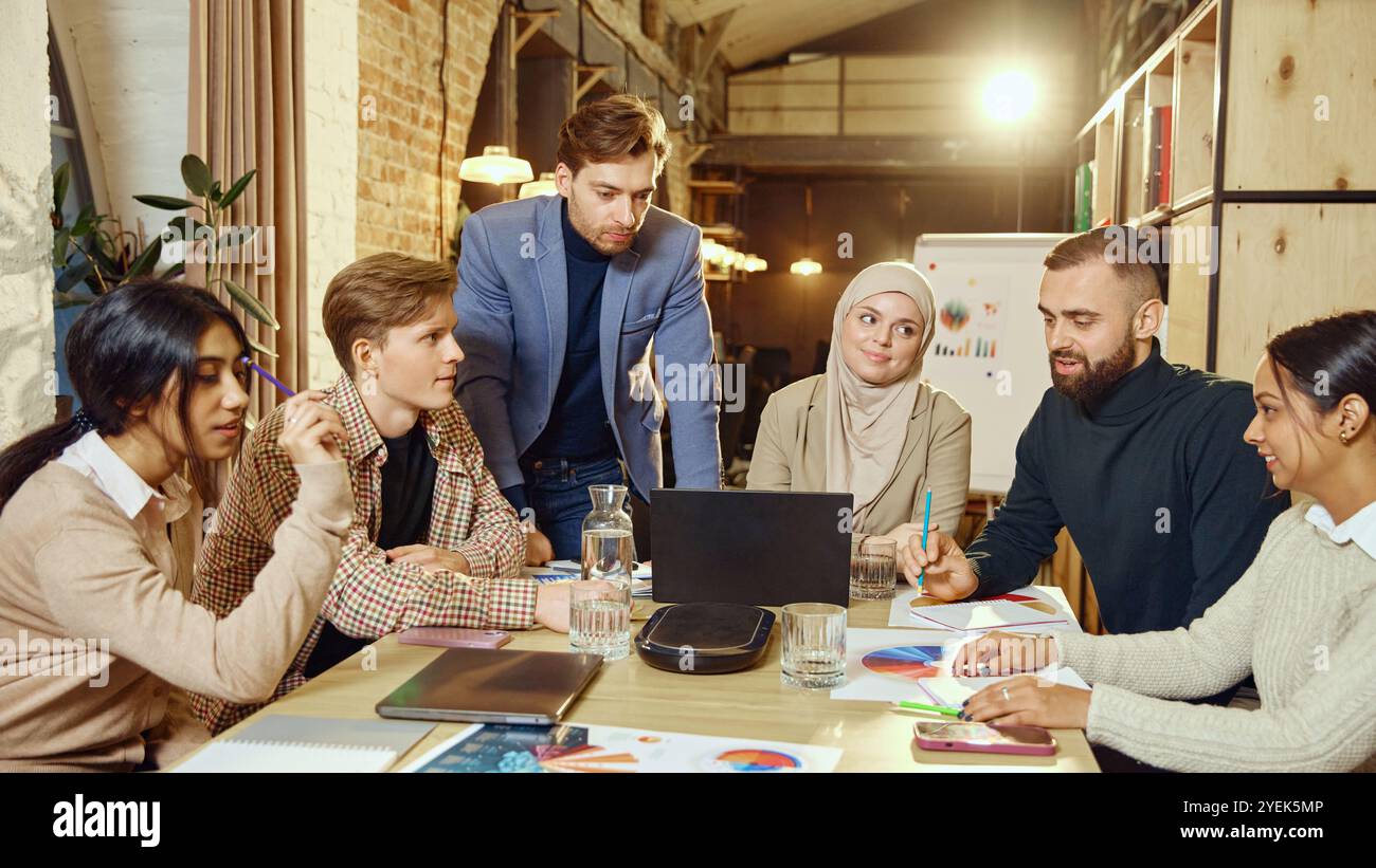 Professionals participate in business planning session, using graphs ...