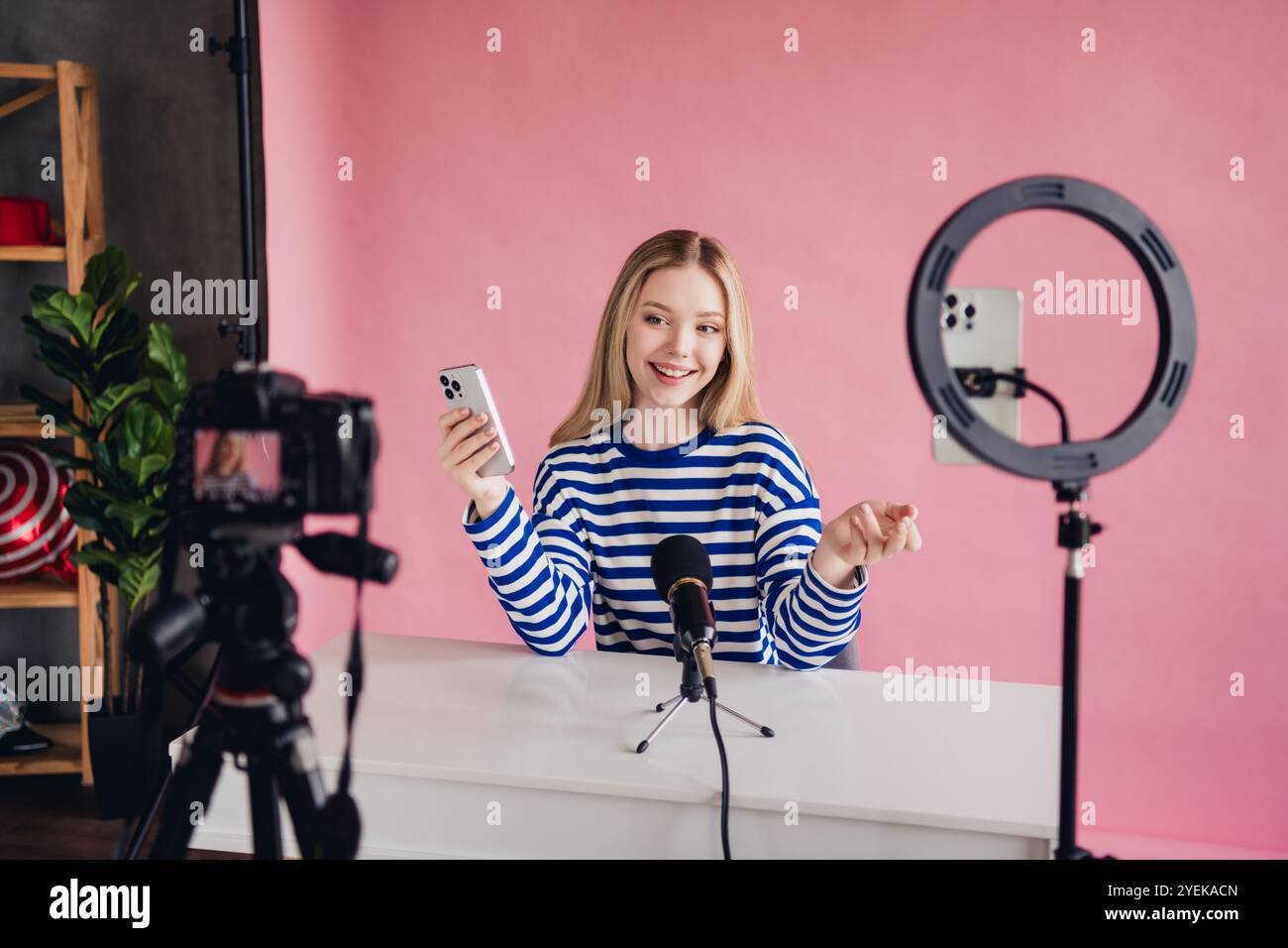 Photo of cute girl influencer speaking in studio interior with ...