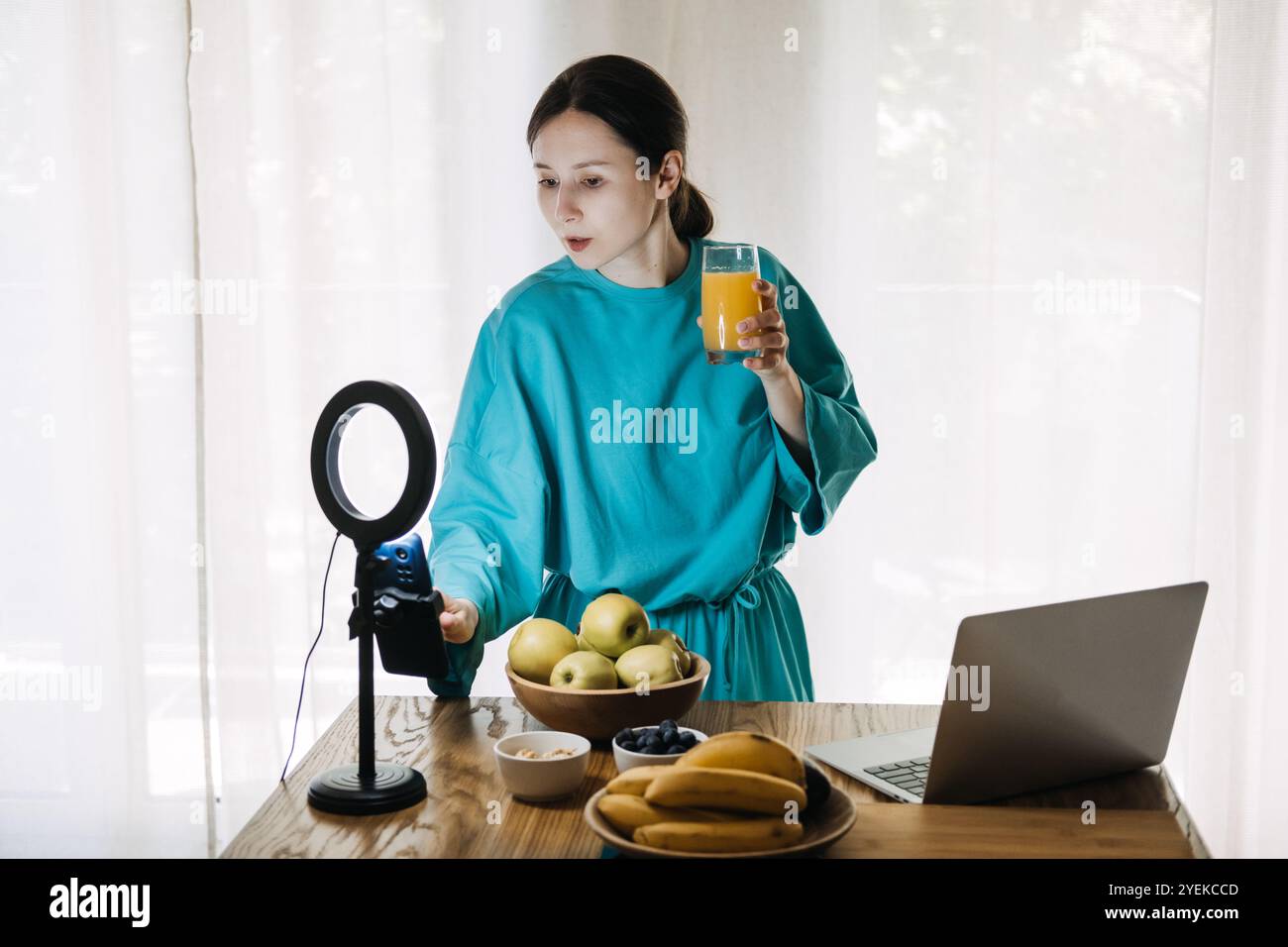 Young woman creating social media content on healthy lifestyle with ...