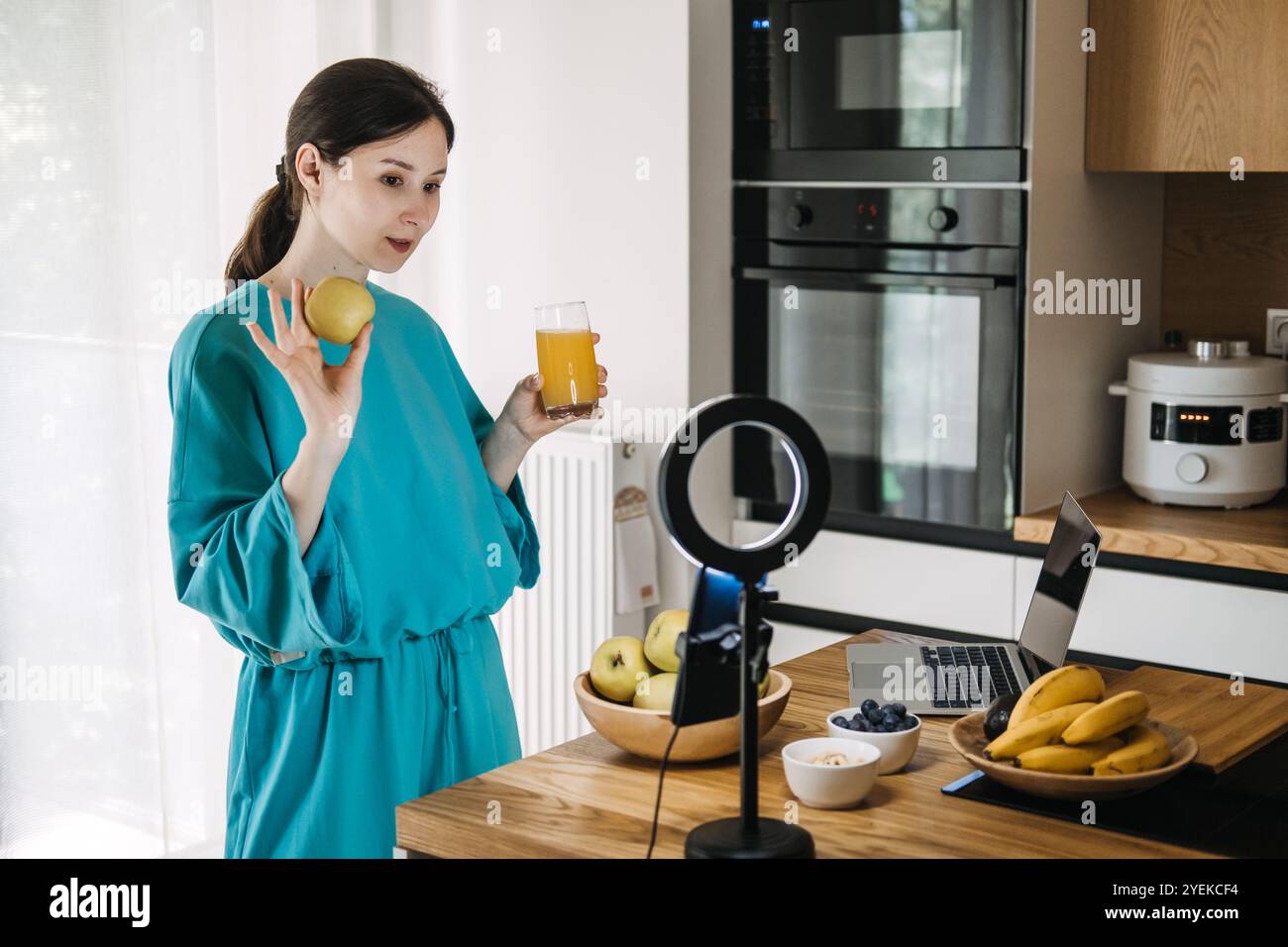 Young woman creating social media content on healthy lifestyle with ...