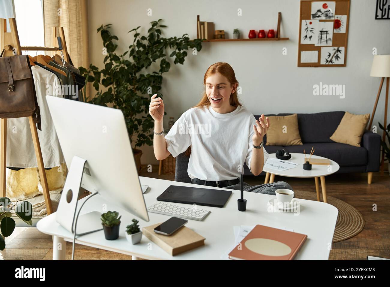 A young man excitedly interacts with his digital design projects in a ...