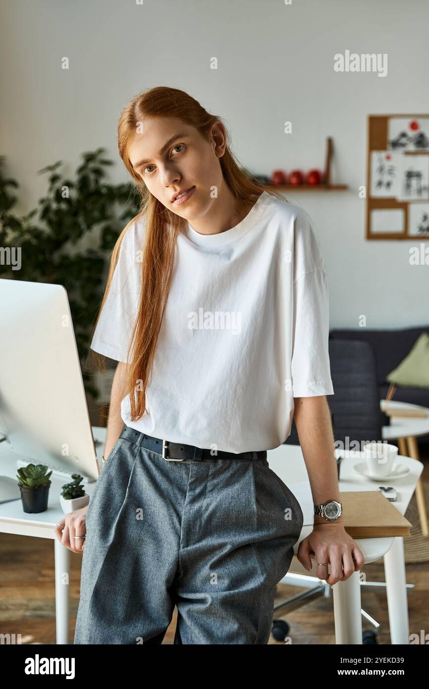 Bright sunlight fills a stylish workspace as a young man leans casually ...