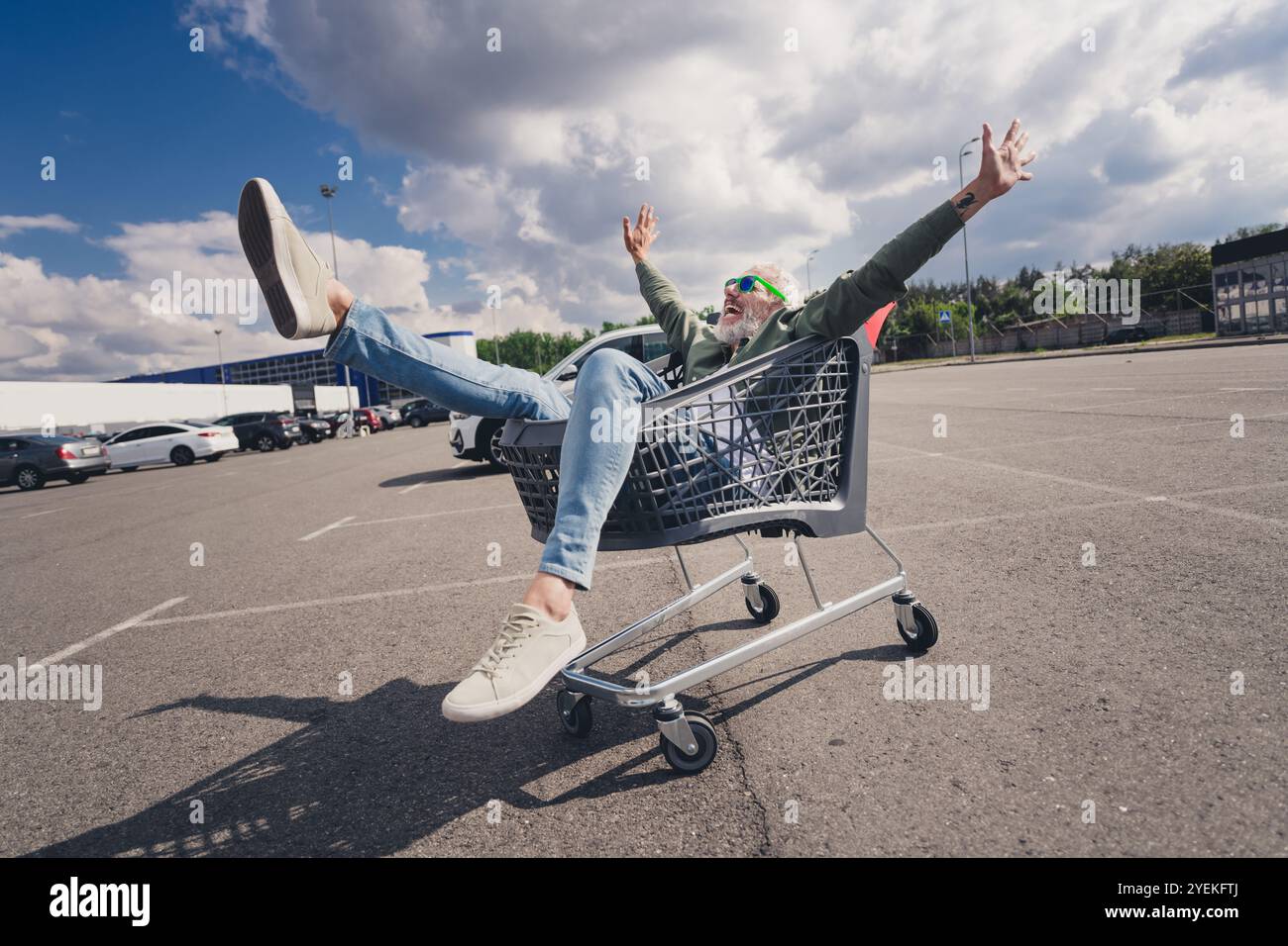 Full size photo of pensioner man have fun enjoy riding shopping cart ...