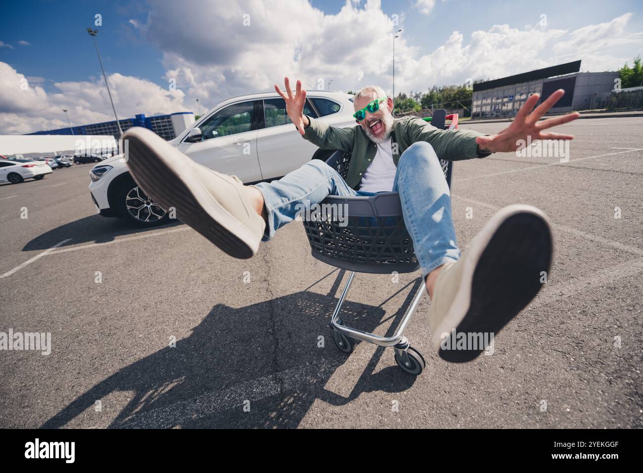 Full size photo of pensioner man riding shopping cart loading groceries ...