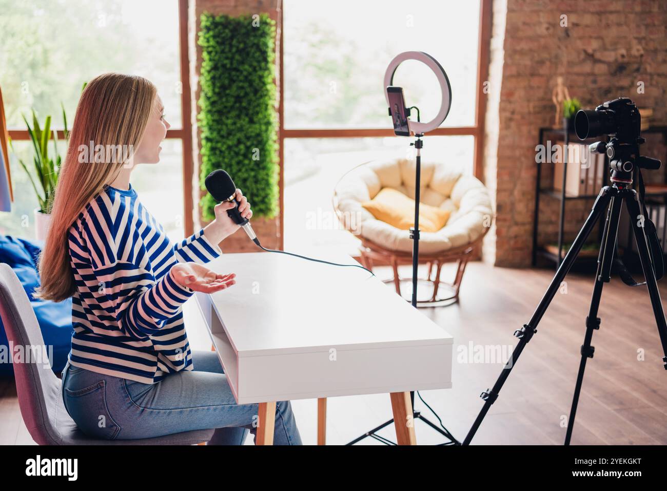 Profile side photo of attractive girl influencer speaking in studio ...