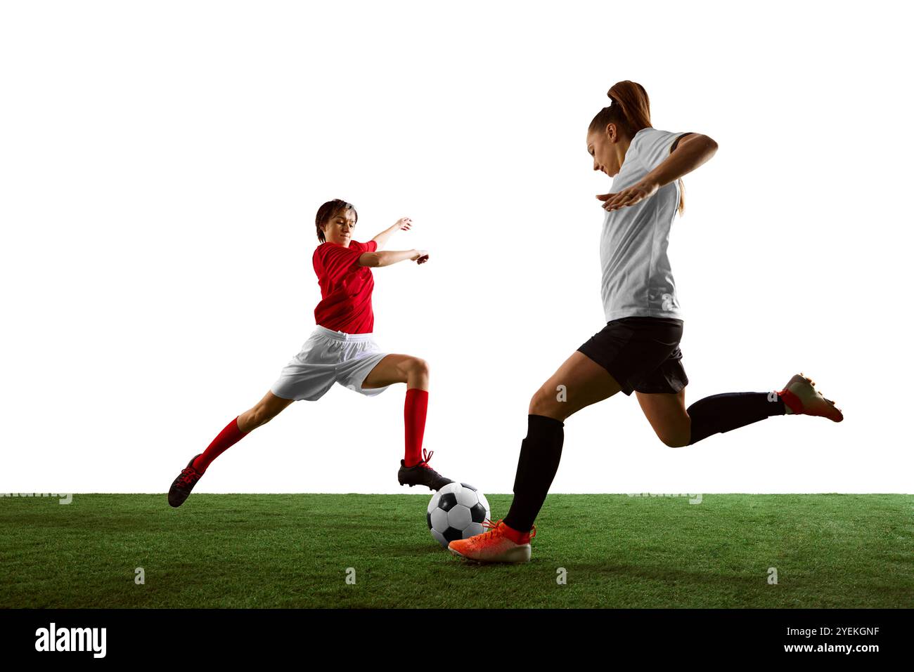 Two young women, female soccer players challenge each other for ball ...