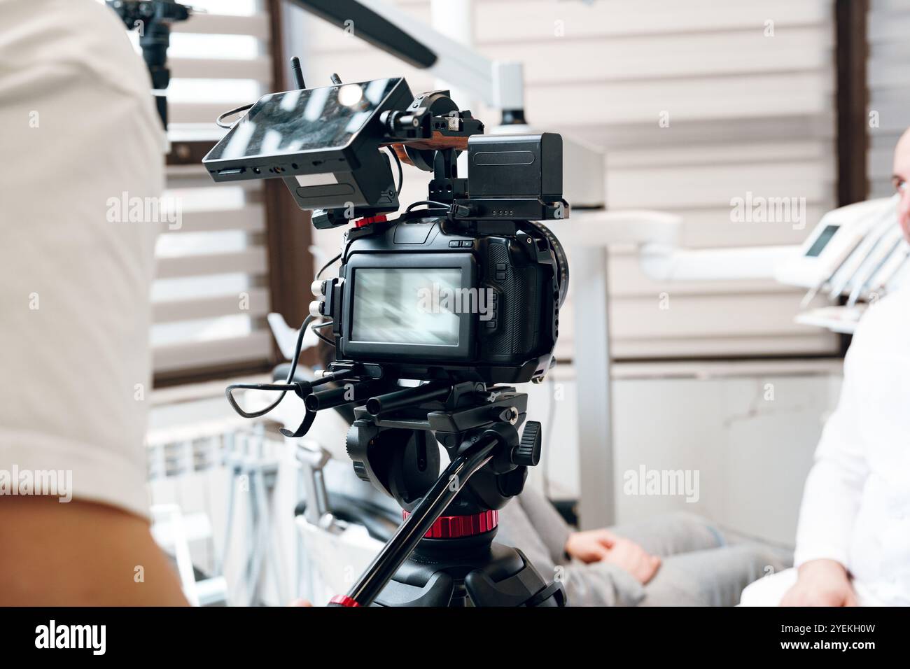 A person operates a handheld gimbal stabilizer with a camera in a ...