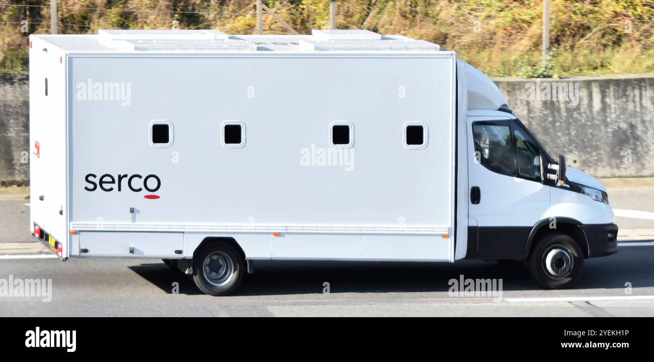 Side view white prisoner transport van & driver at work for Serco ...