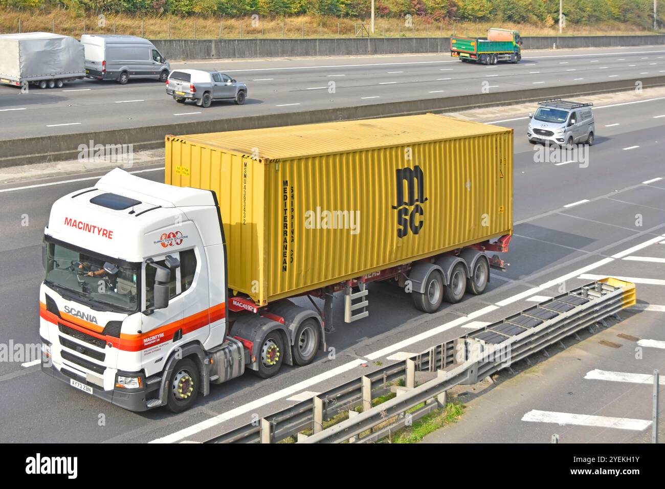 MSC shipping container on articulated skeletal trailer towed by ...